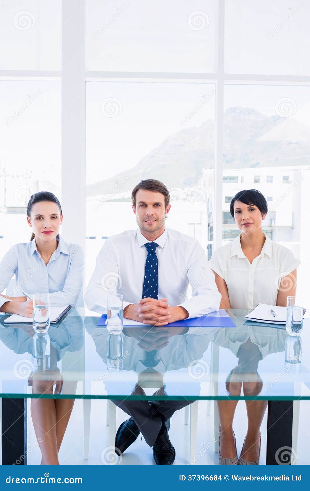 Smartly Dressed Young Executives Sitting at Desk Stock Photo - Image of ...