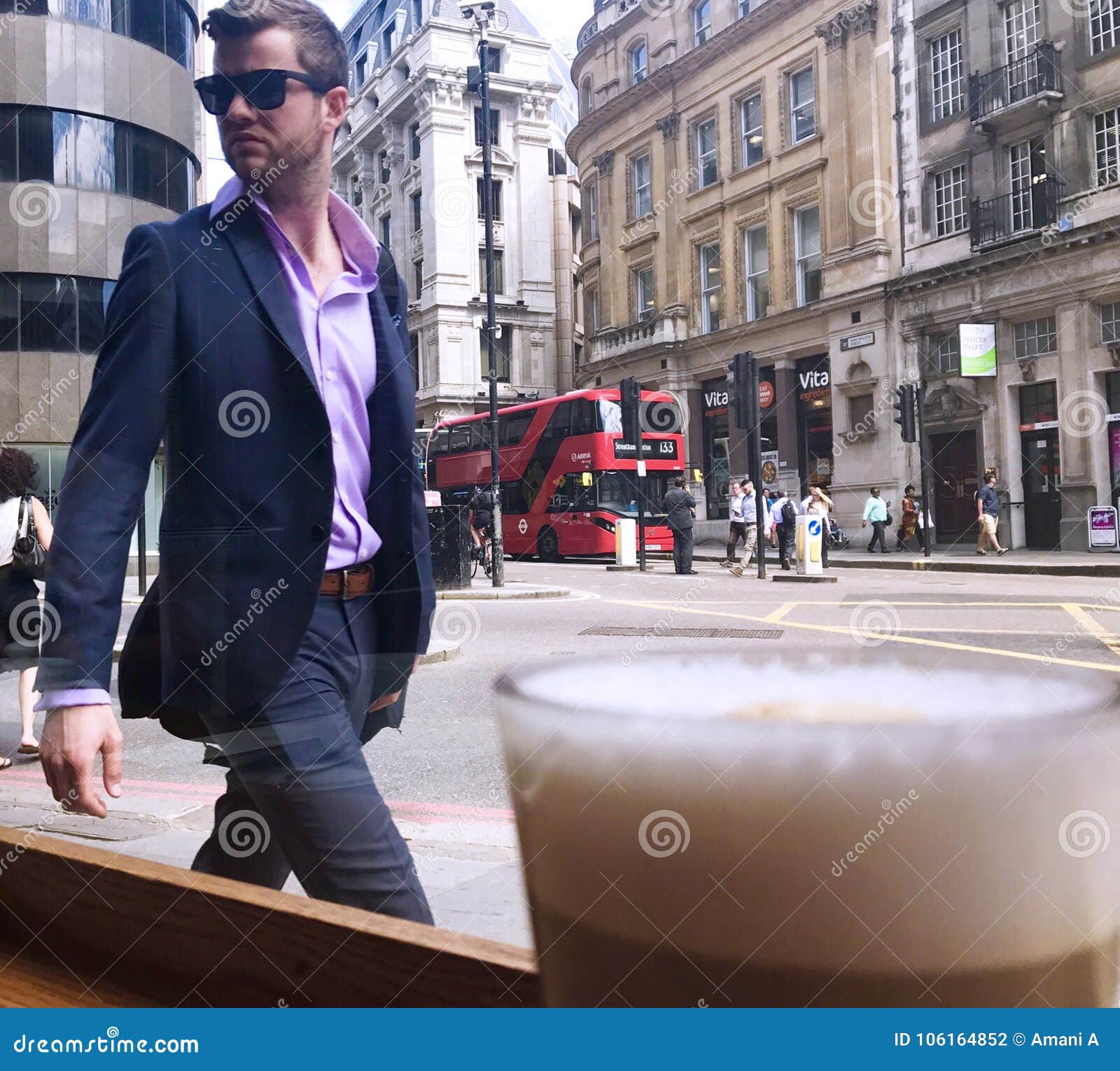 A Smartly Dressed Young Man Looks at His Own Reflection in a Coffee ... A Smartly Dressed Young Man Looks at His Own Reflection in a Coffee ...