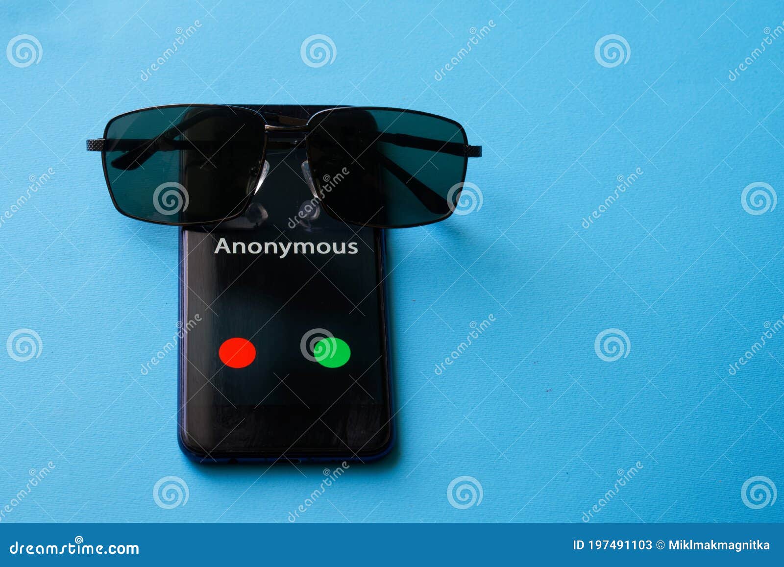 A Smartphone with an Anonymous Call Lies on a Blue Surface Next To ...