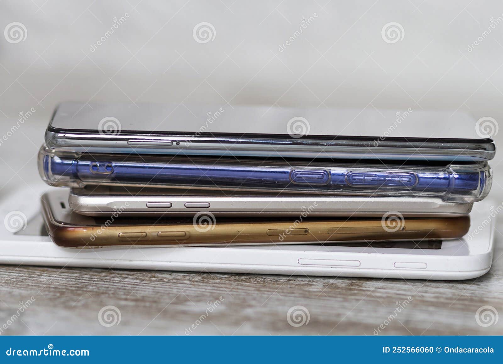Smartphones pile and cable stock photo. Image of object - 252566060