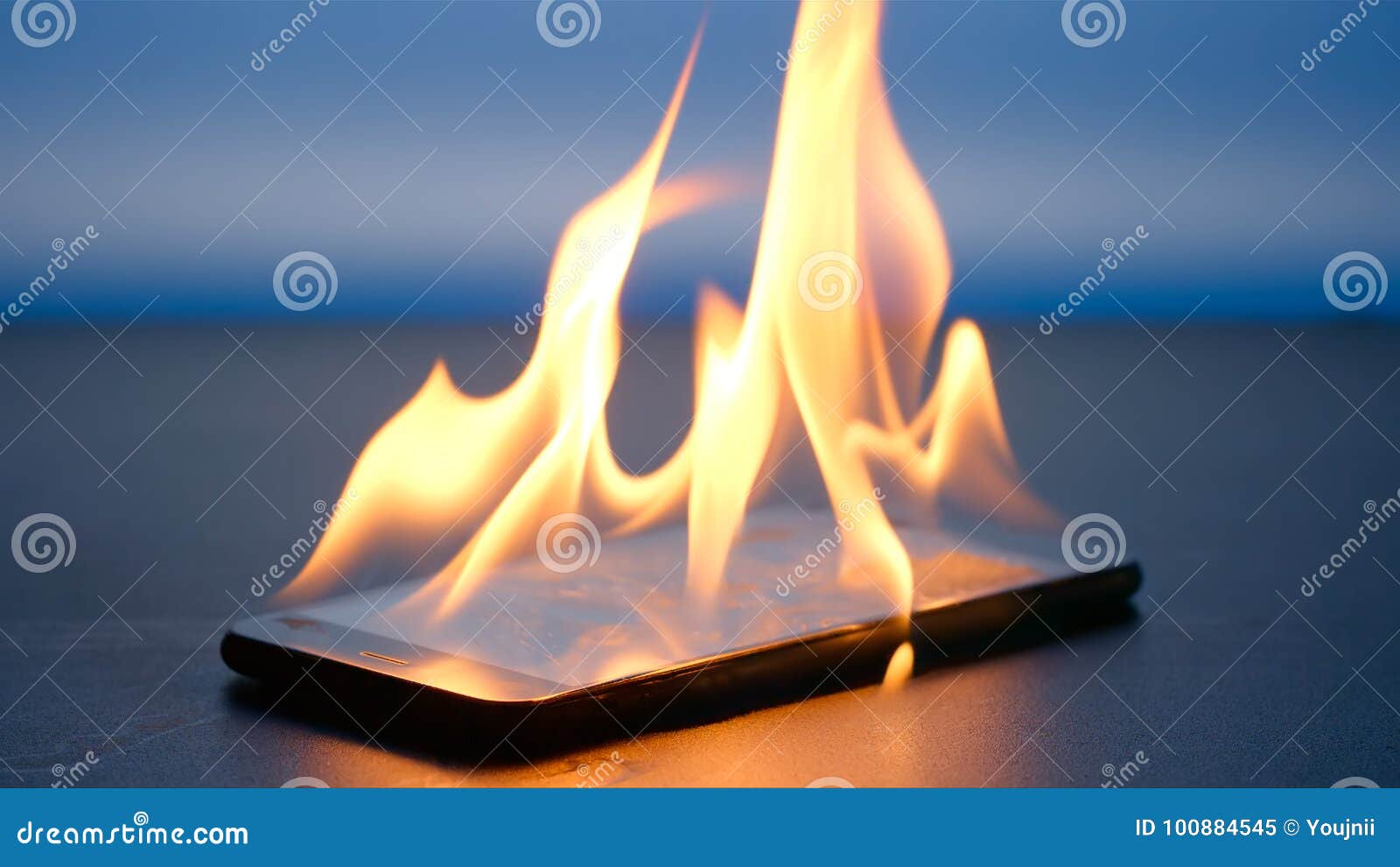 Smartphone is Burning on a Table on a Blue Background Stock Image ...