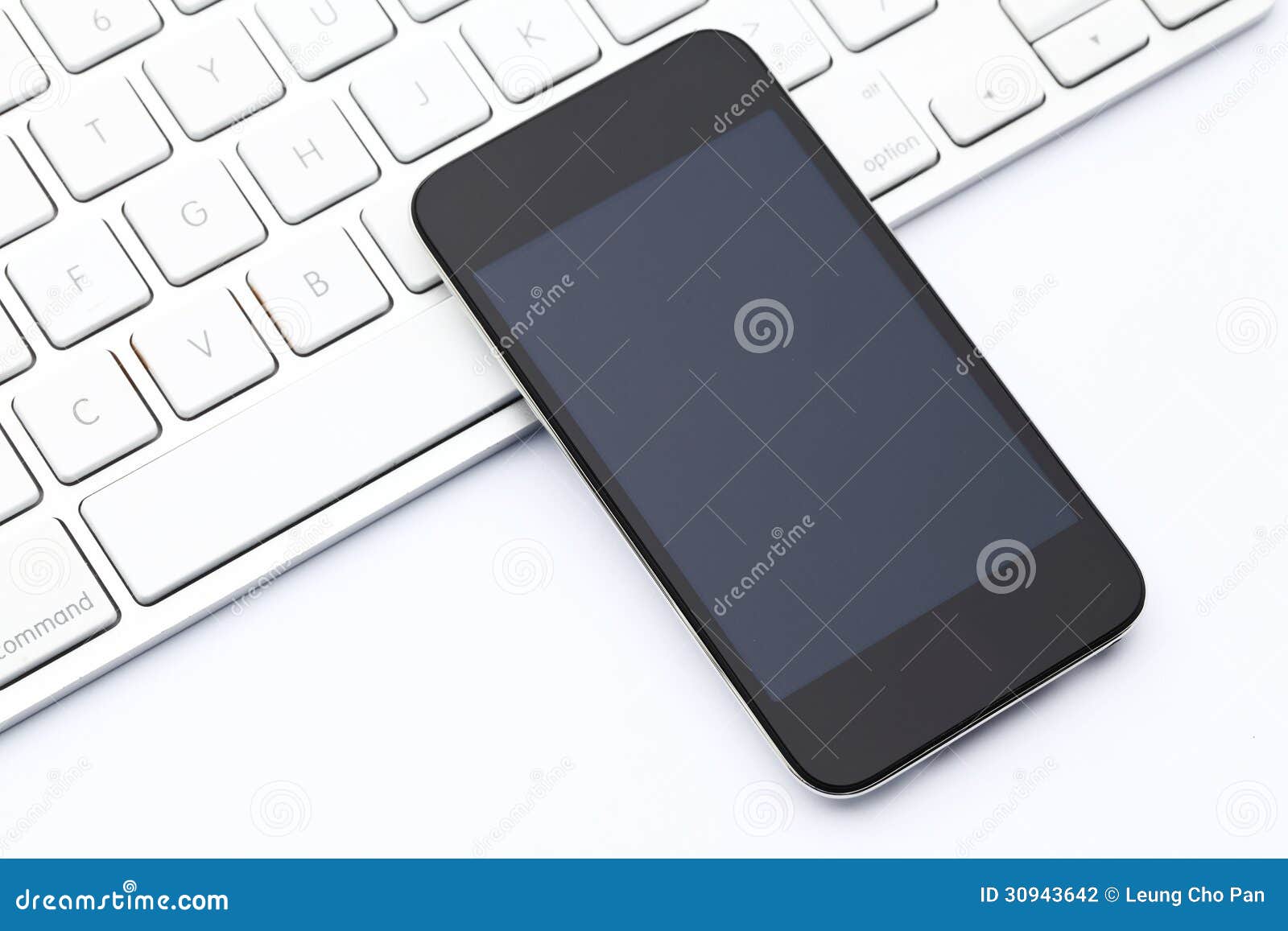 Smartphone on Computer Keyboard Stock Photo - Image of communication ...