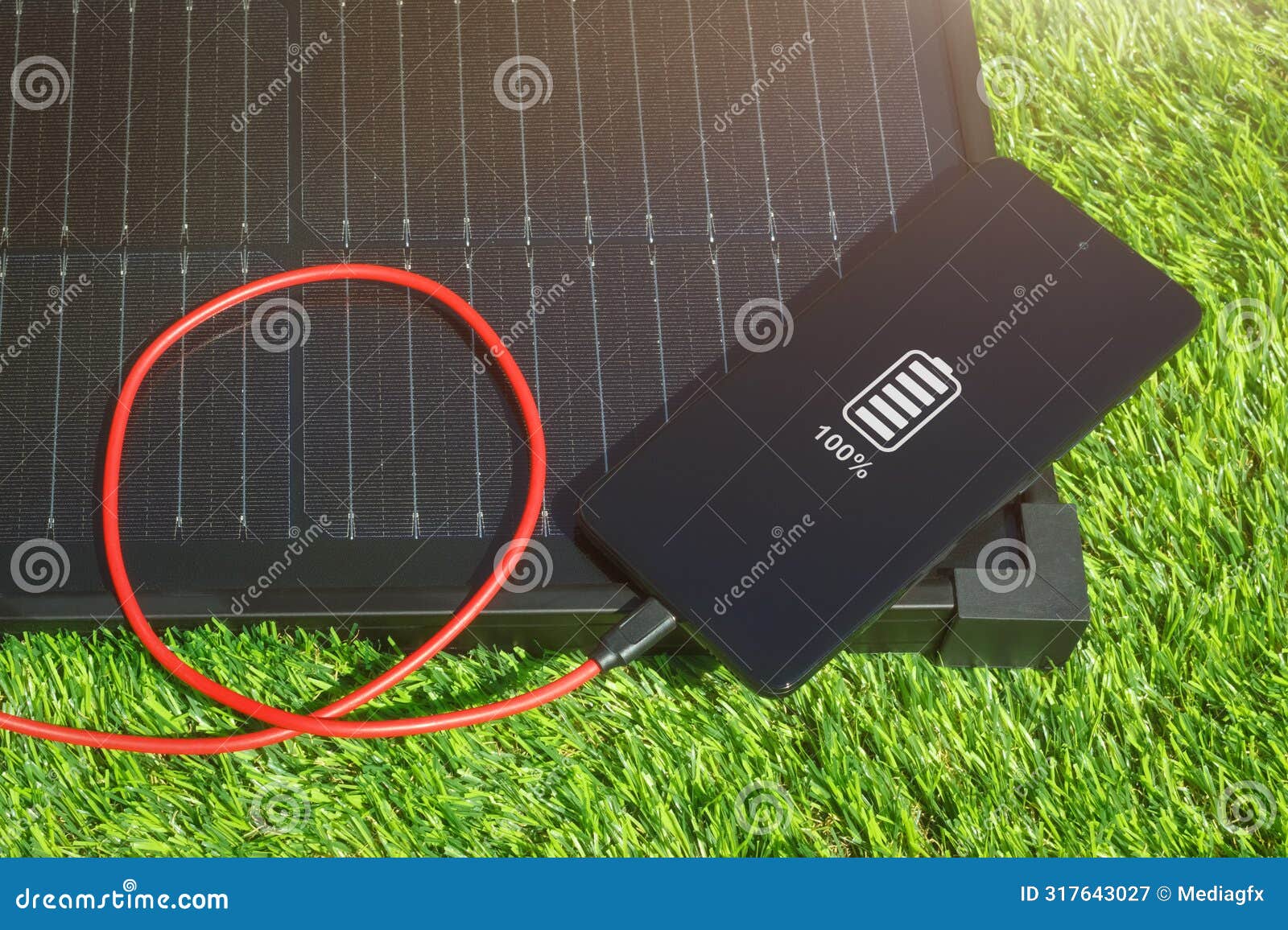 The Smartphone is Fully Charged with Solar Panel. Outdoors Electrical ...