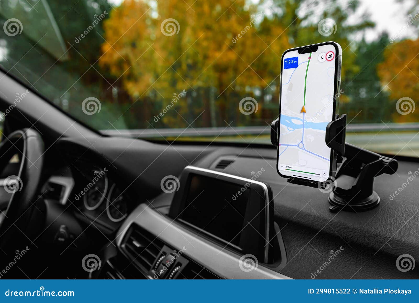 Smartphone with Navigation Route on Screen Mounted on Phone Holder at ...