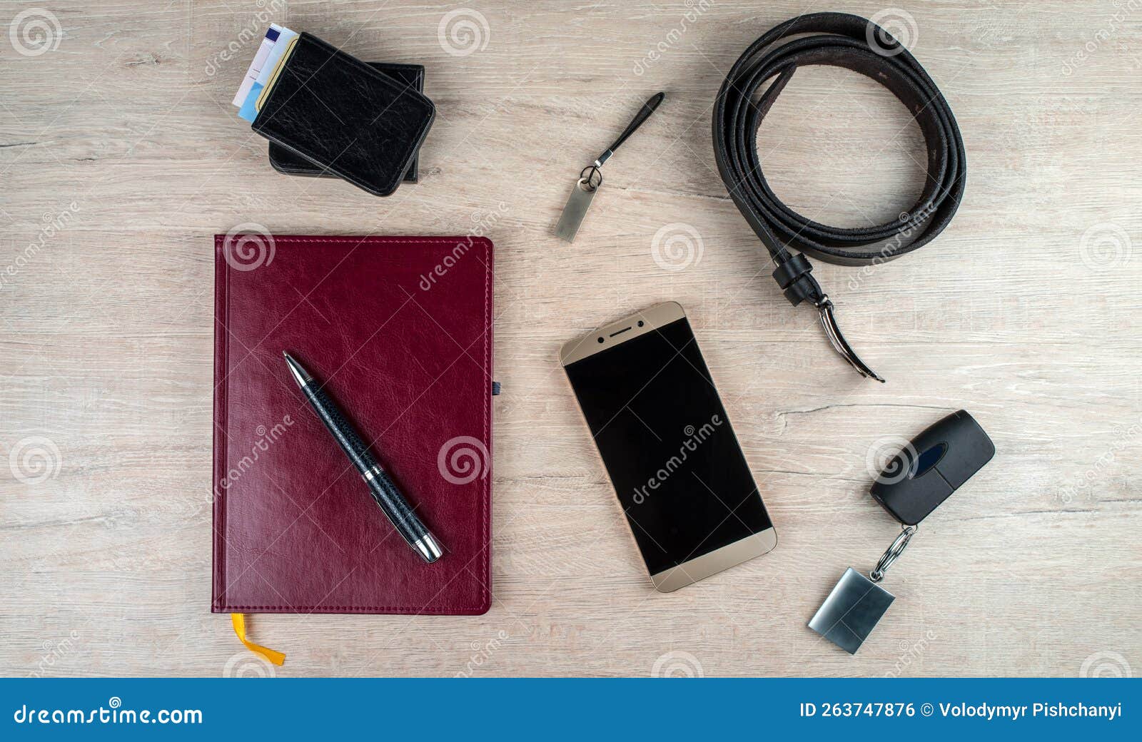 Smartphone, a Notepad, a Ballpoint Pen, a Leather Belt, and Other Men`s ...
