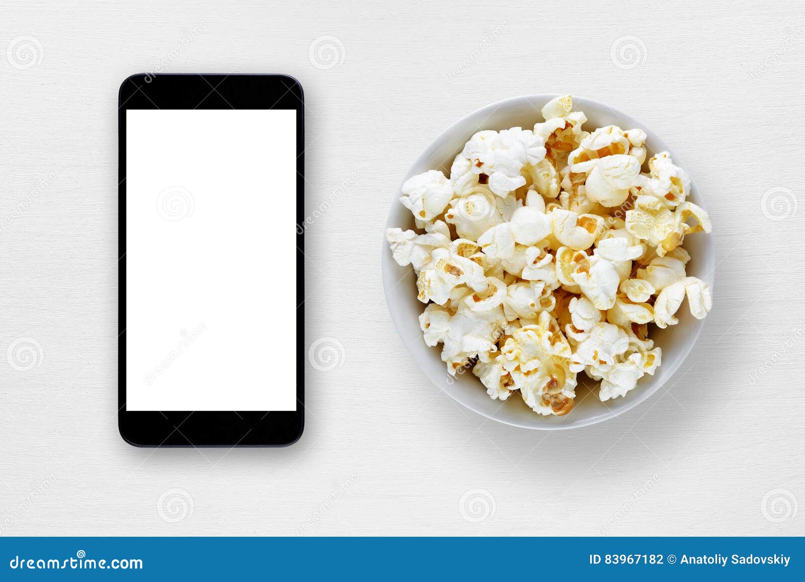 Smartphone and Popcorn in Bowl on Table Stock Photo - Image of ...