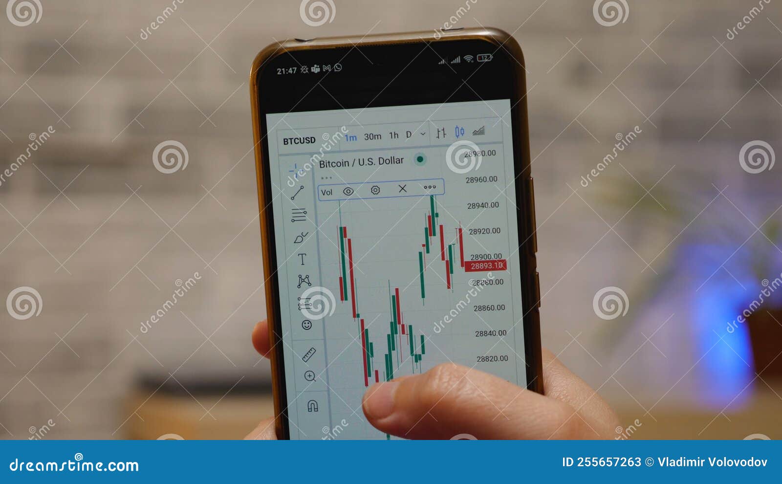 On the Smartphone Screen is a Graph of the Bitcoin Cryptocurrency Value ...