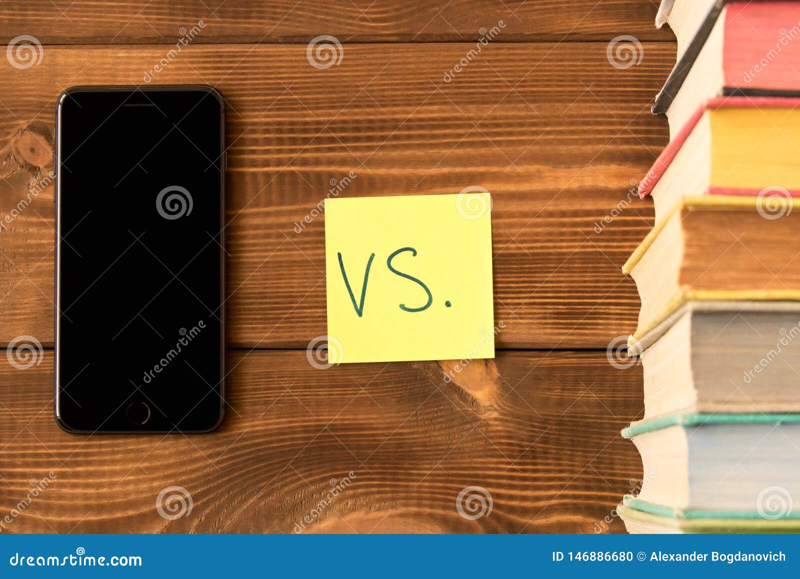 Smartphone and a Stack of Books on a Wooden Table. the Concept of ...