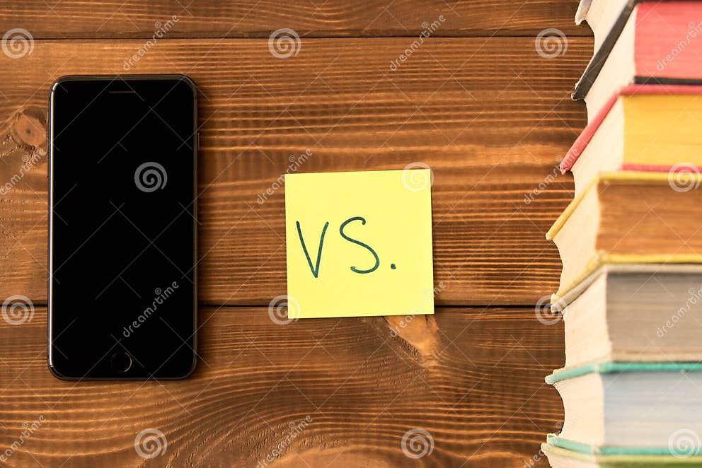 Smartphone and a Stack of Books on a Wooden Table. the Concept of ...