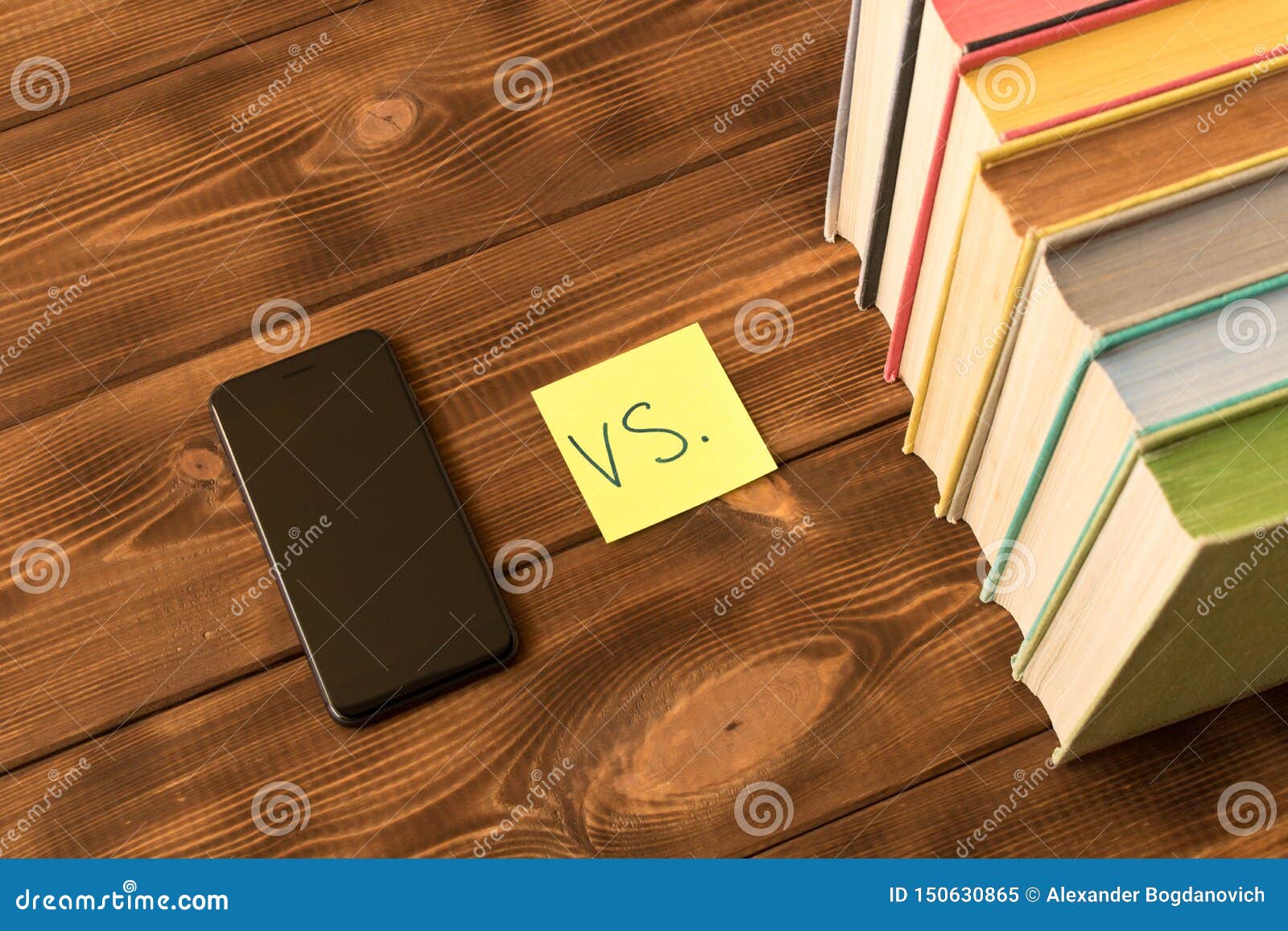 Smartphone and a Stack of Books on a Wooden Table. the Concept of ...