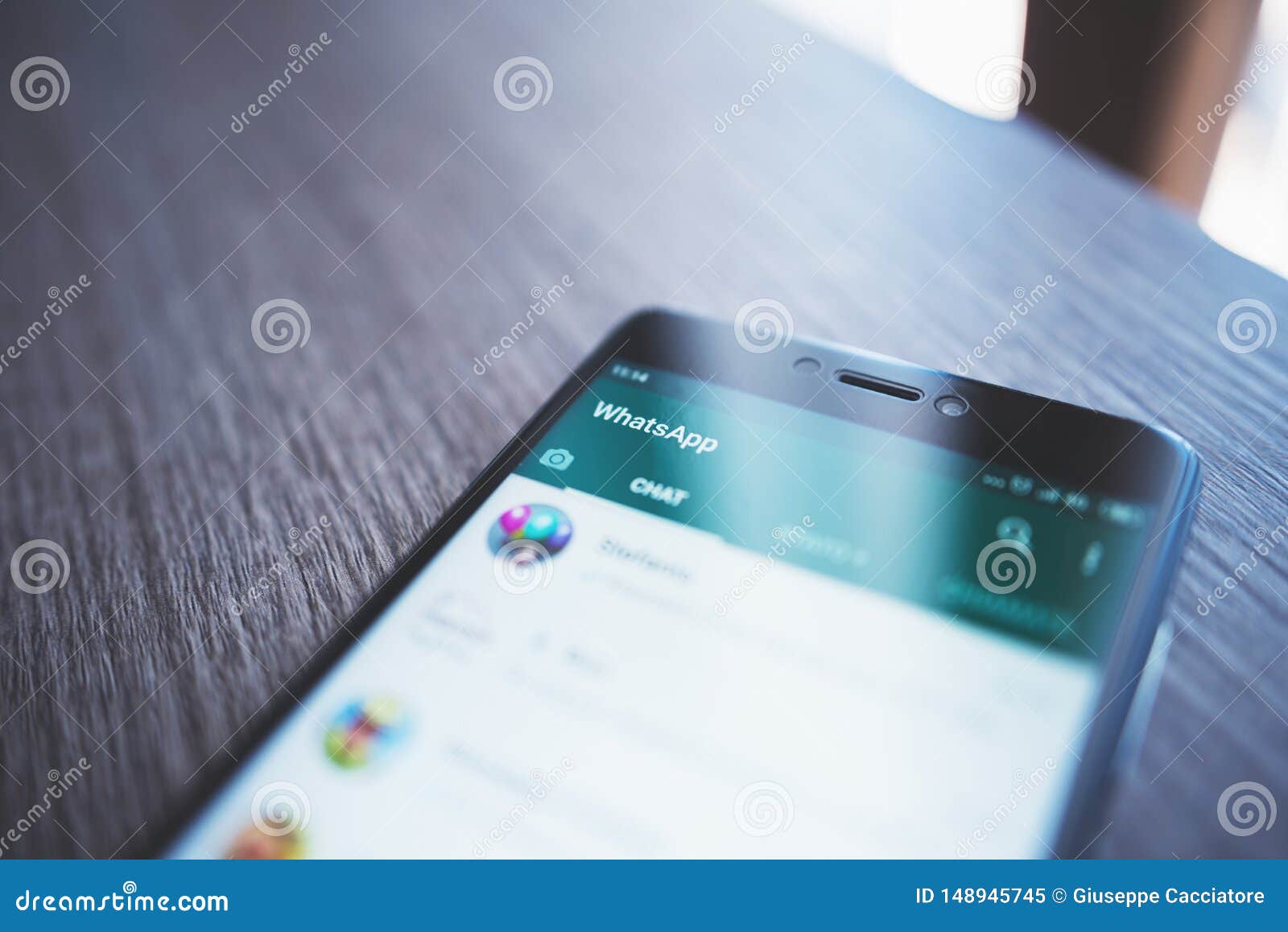 Smartphone With The Whatsapp Messenger On The Screen In A Clenched Hand ...