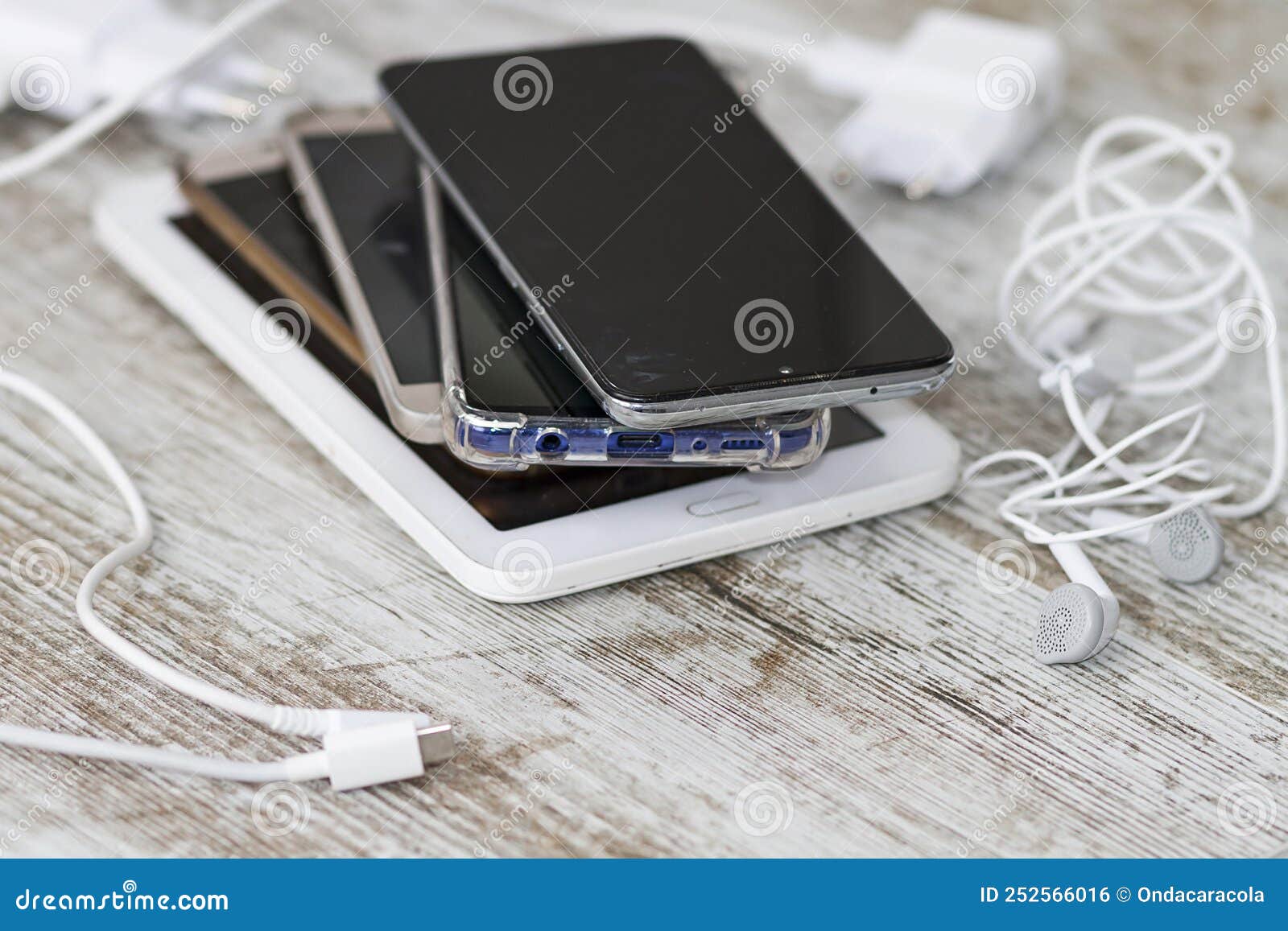 Smartphones pile and cable stock photo. Image of media - 252566016