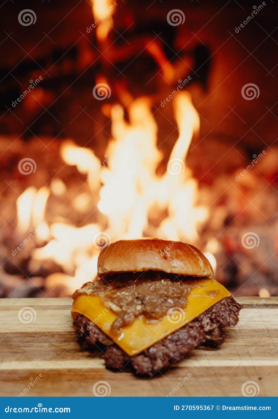 Smashed Cheeseburger on a Wooden Table in Front of a Fireplace. Stock ...