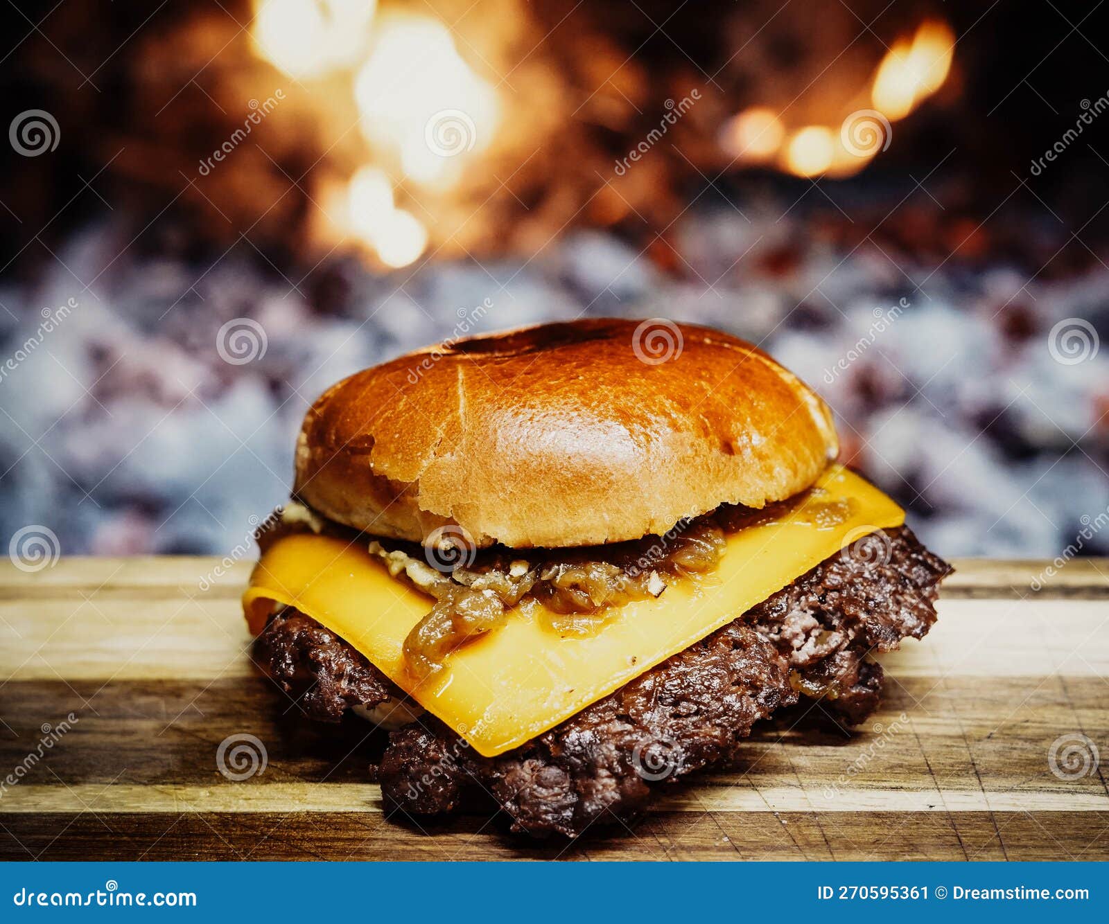 Smashed Cheeseburger on a Wooden Table in Front of a Fireplace. Stock ...