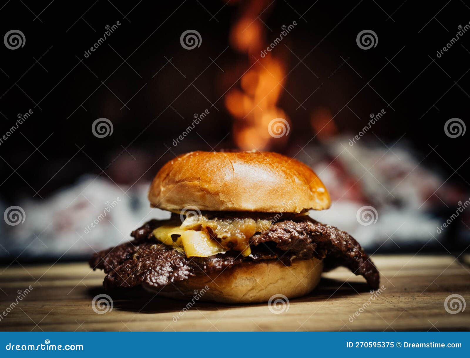 Smashed Cheeseburger on a Wooden Table in Front of a Fireplace. Stock ...