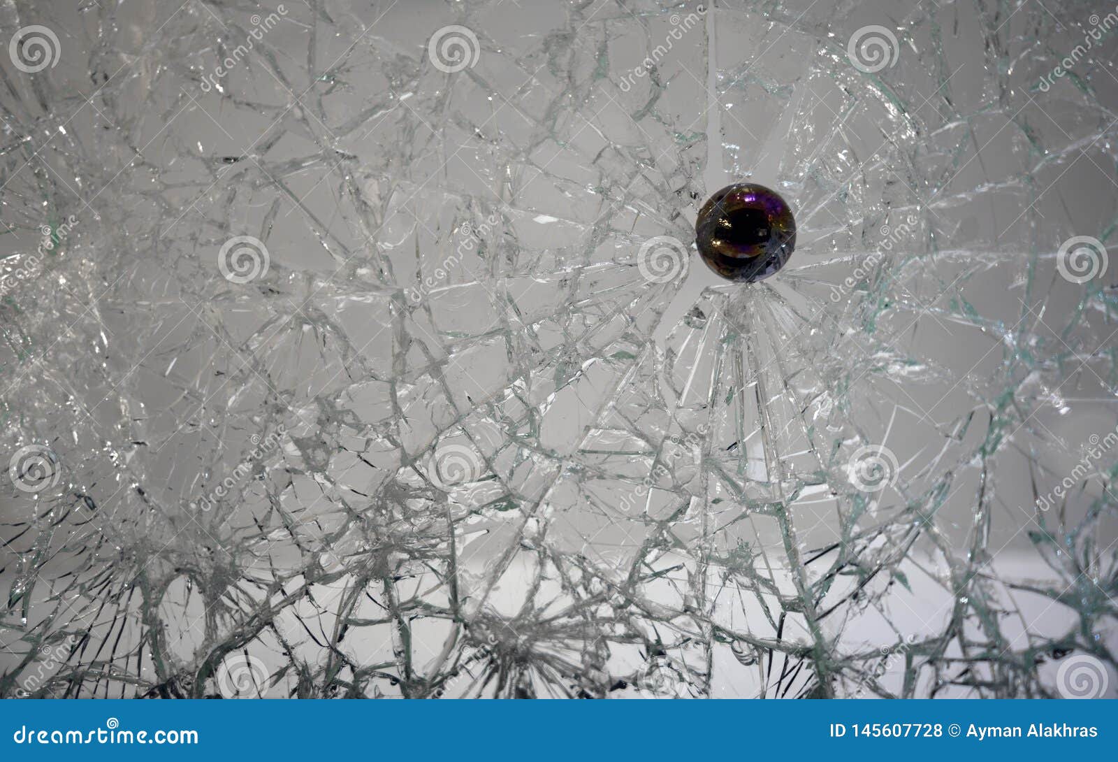 Smashed Glass with Bullet Stuck in Cracks Stock Photo - Image of ...