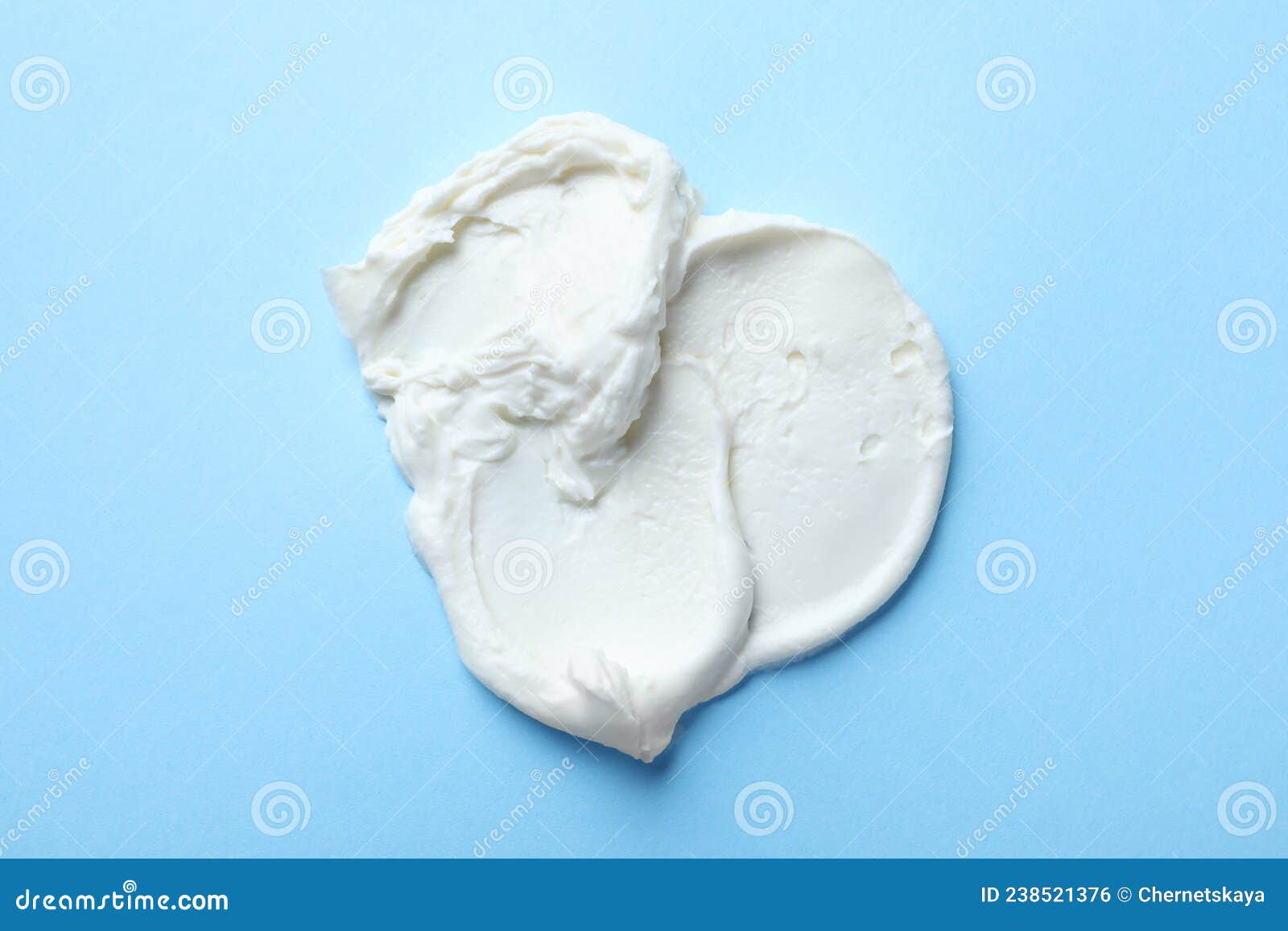 Smear of Delicious Cream Cheese on Light Blue Background, Top View ...