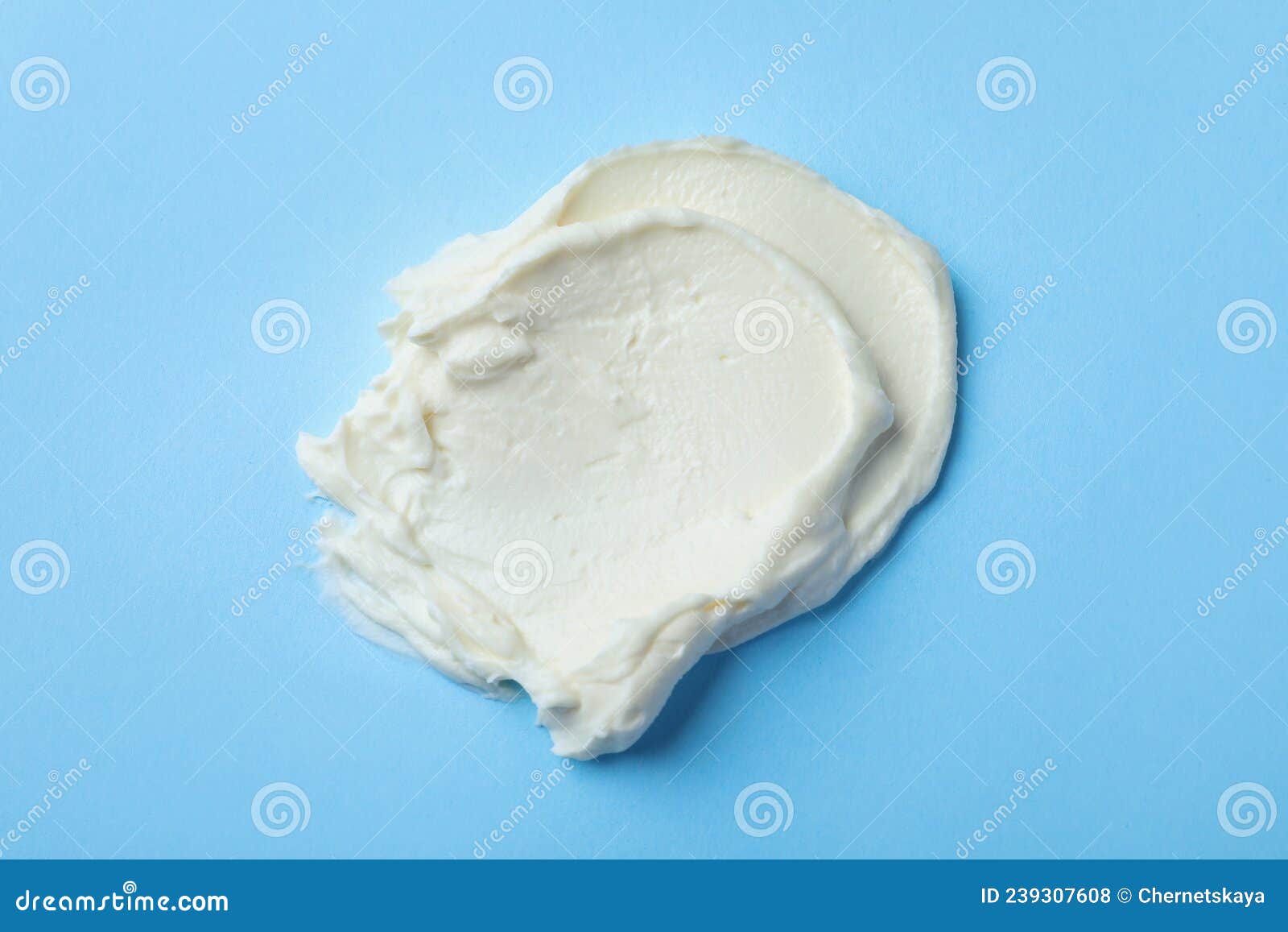 Smear of Delicious Cream Cheese on Light Blue Background, Top View ...