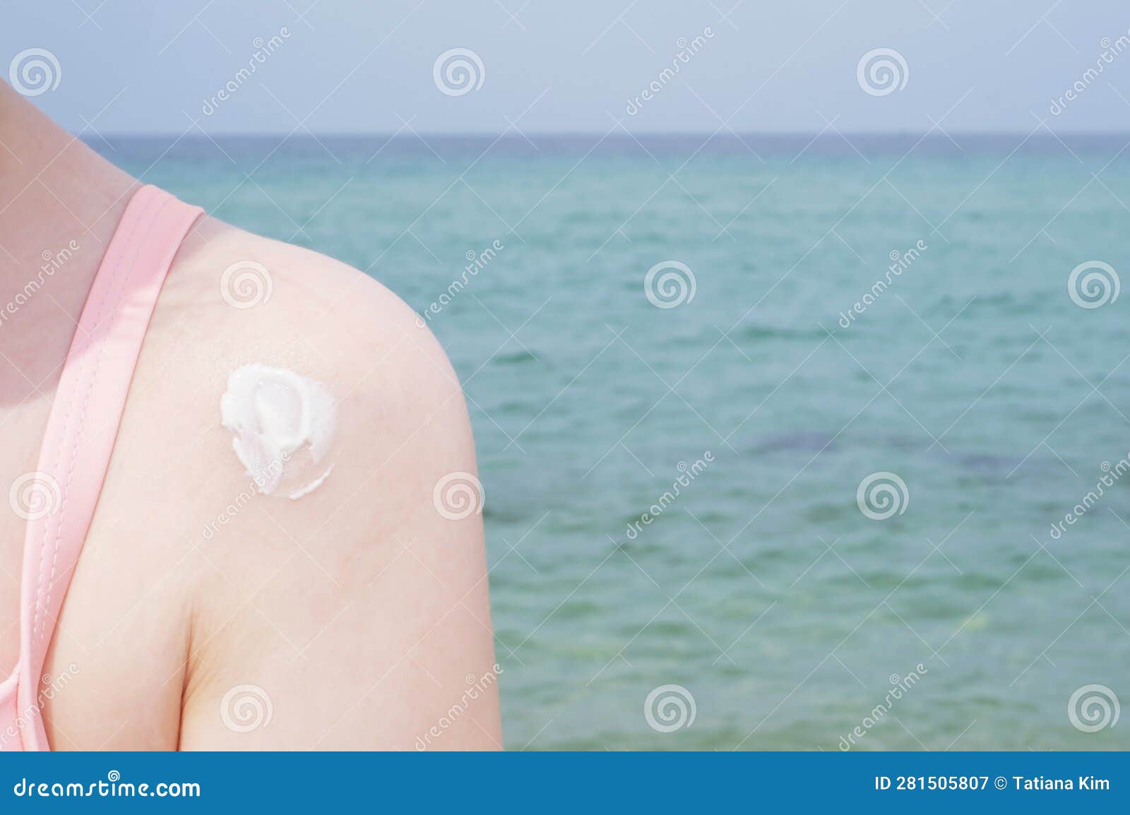 Smear of Sunscreen on Female Shoulder Against the Backdrop of the Sea ...