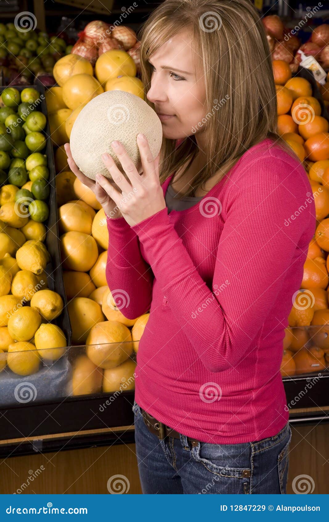 Smelling fruit stock image. Image of grocery, holding - 12847229