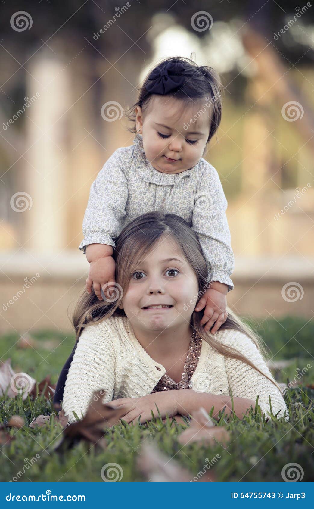 Smile two sisters stock image. Image of teens, baby, grass - 64755743