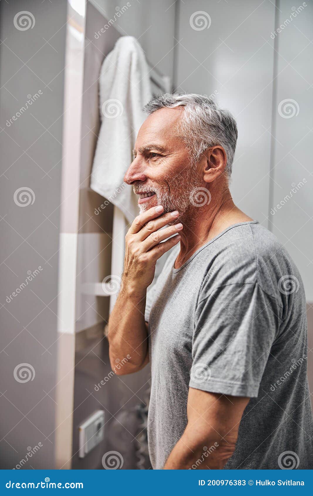 Smiley Aged Gentleman Checking Out His Beard In The Mirror Stock Image
