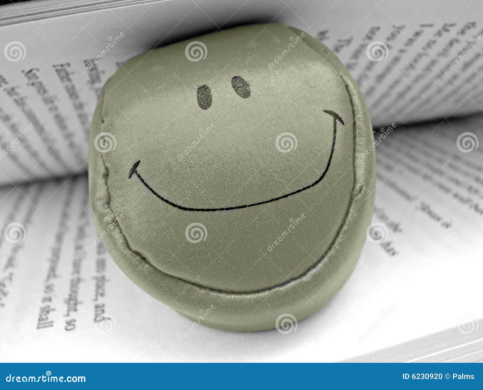 Smiley face ball in book stock photo. Image of closeup - 6230920