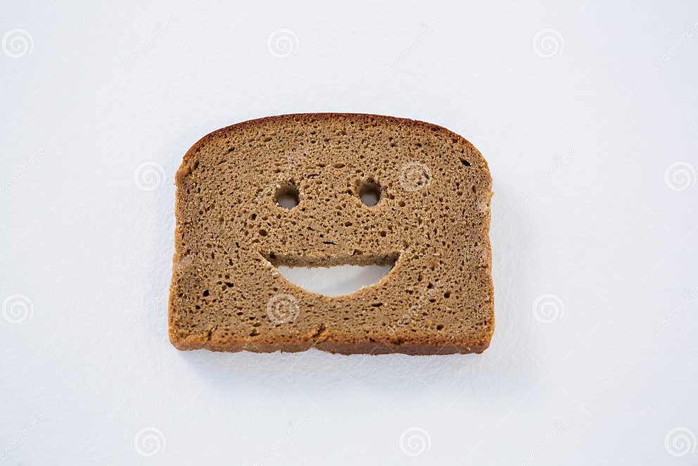 Smiley face on bread slice stock photo. Image of shot - 84093840