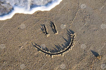 Smiley face in the sand stock photo. Image of smiling - 10003408