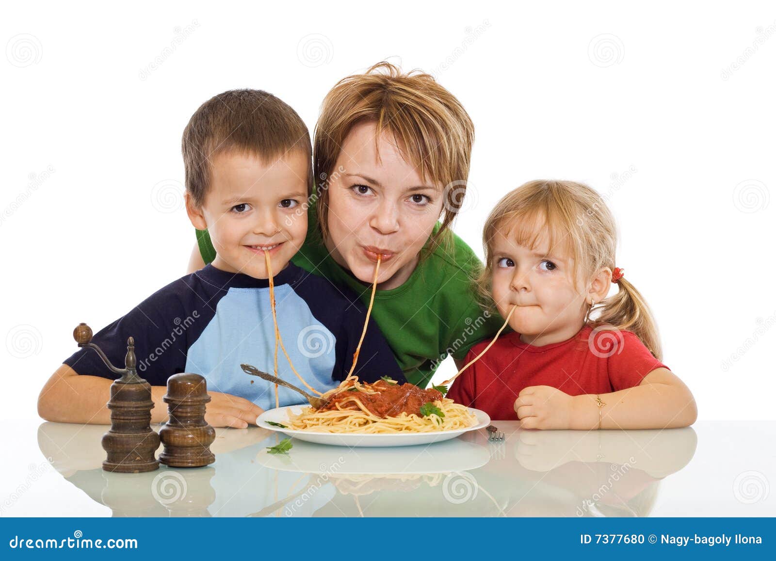 Smiley family eating pasta stock photo. Image of cute - 7377680