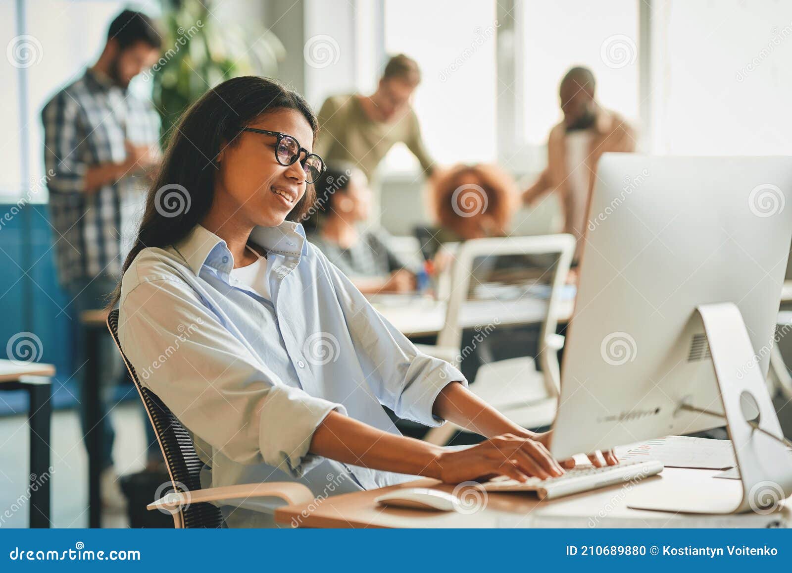 Smiley Female Office Worker Using Computer at Desk Stock Photo - Image ...