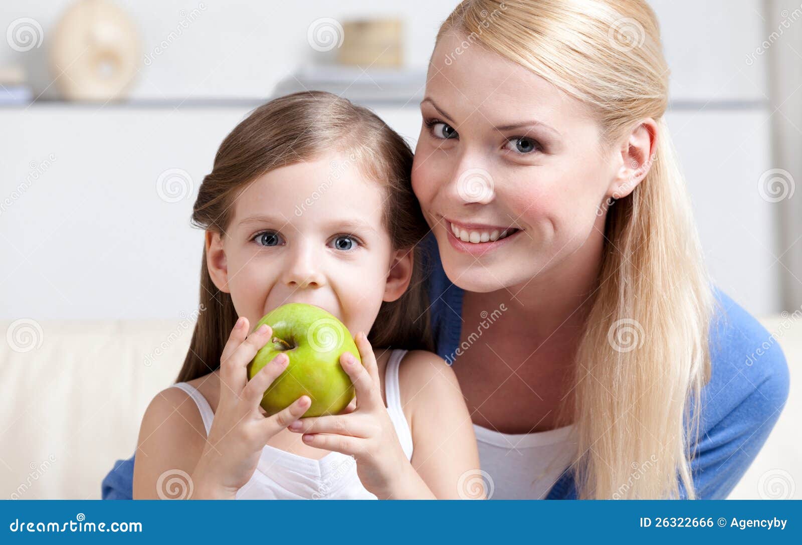 Smiley Mom with Her Eating Apple Daughter Stock Photo - Image of brown ...