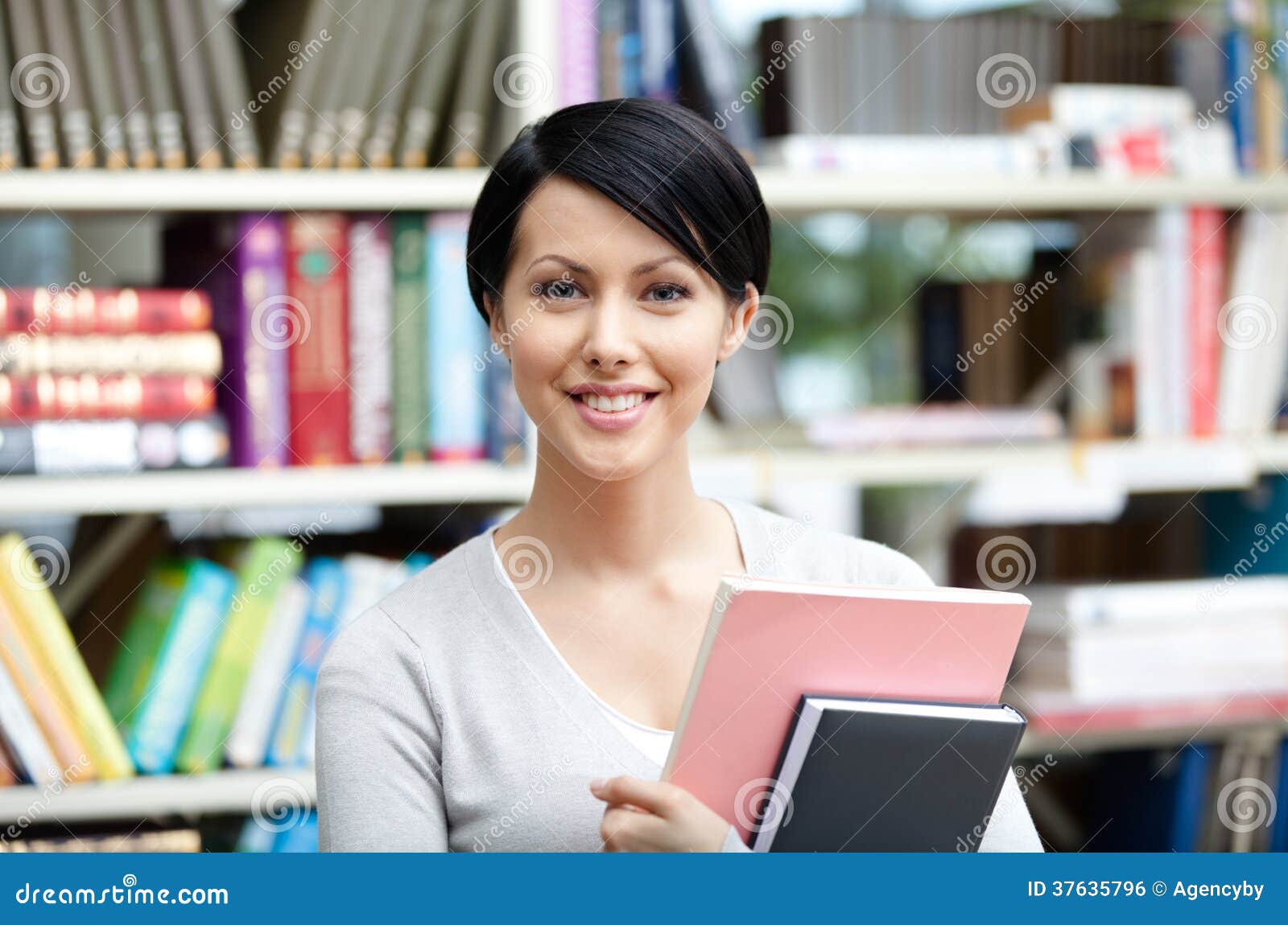 Smiley Student with Book at the Library Stock Photo - Image of books ...