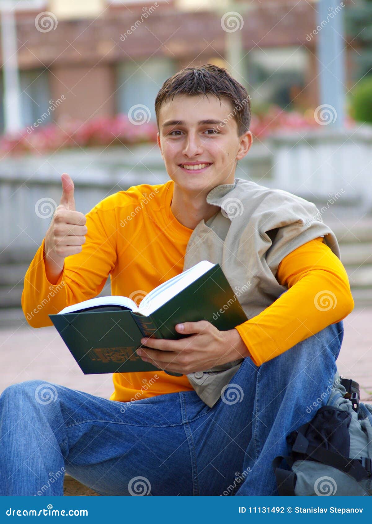 Smiley Student with Book and Thumb Up Stock Photo - Image of student ...