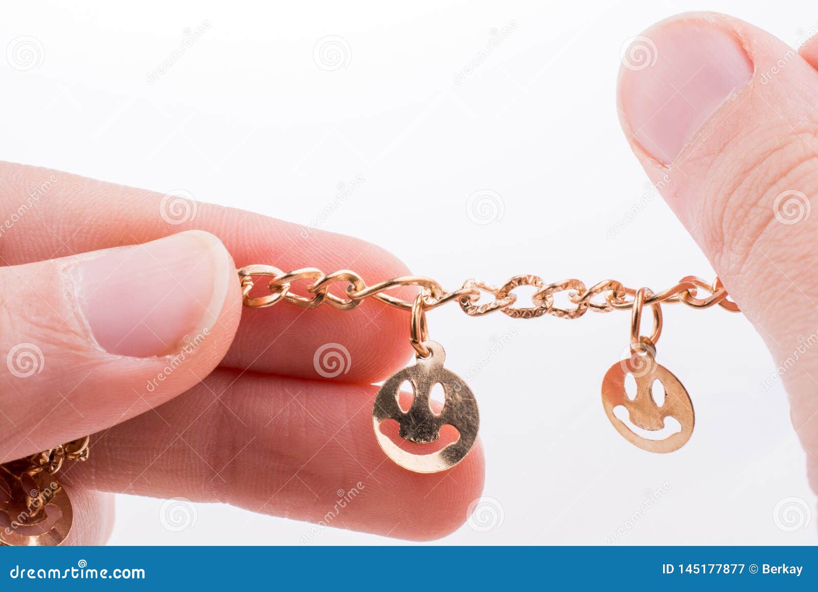 Smileys on a chain in hand stock image. Image of hand - 145177877