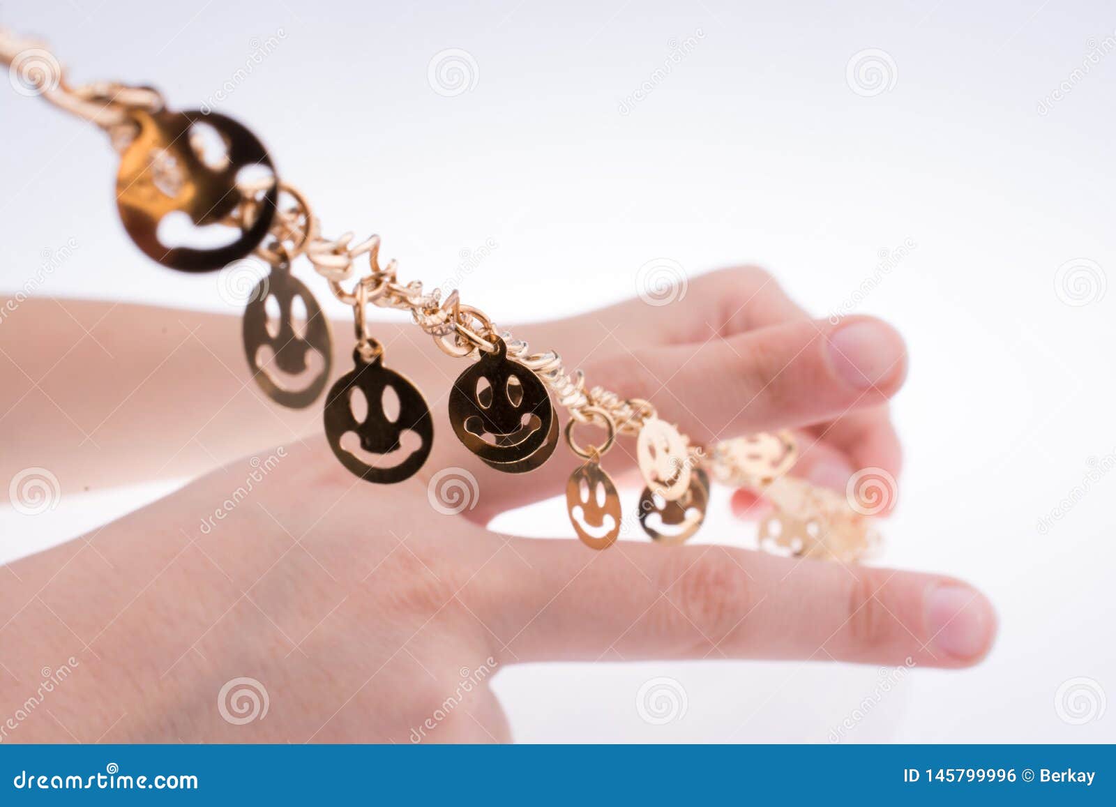 Smileys on a chain in hand stock photo. Image of emotion - 145799996