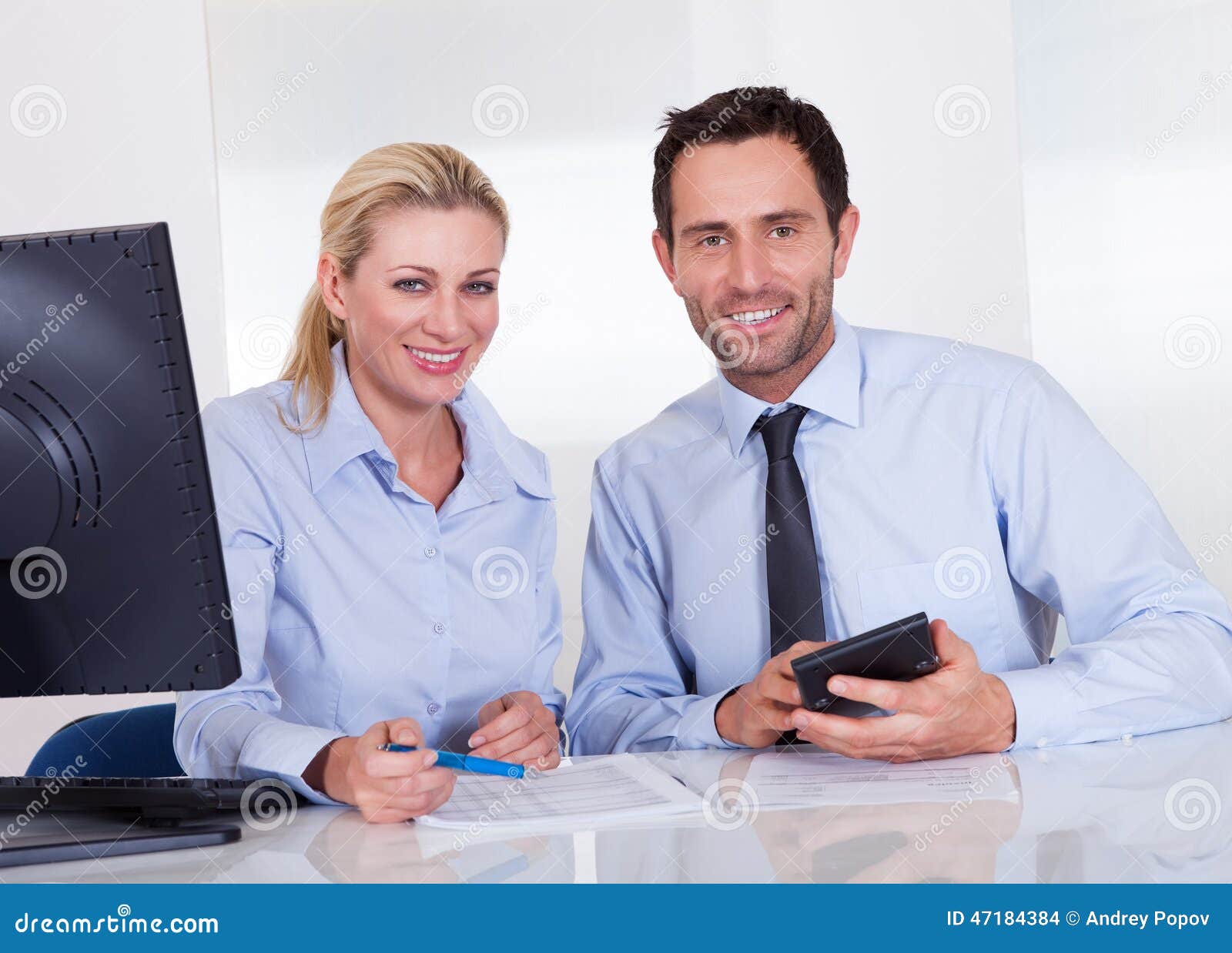 Smiling Accountants Discussing Reports Stock Photo - Image of ...
