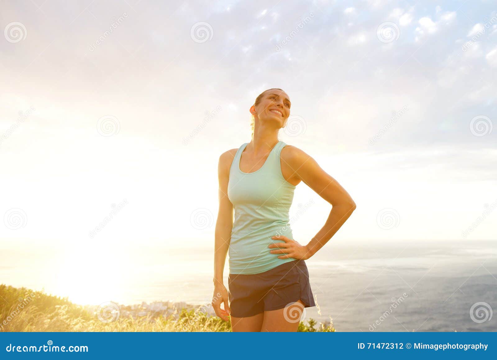 Smiling Active Woman Standing Outside during Sunset Stock Photo - Image ...