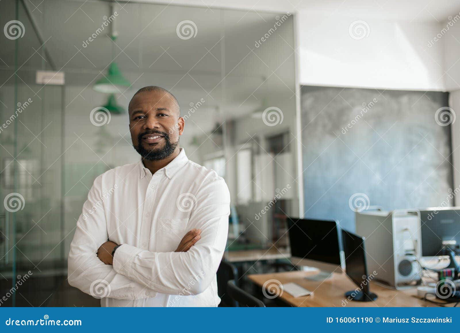 Smiling African American Businessman Standing Alone in a Large Office ... Smiling African American Businessman Standing Alone in a Large Office ...