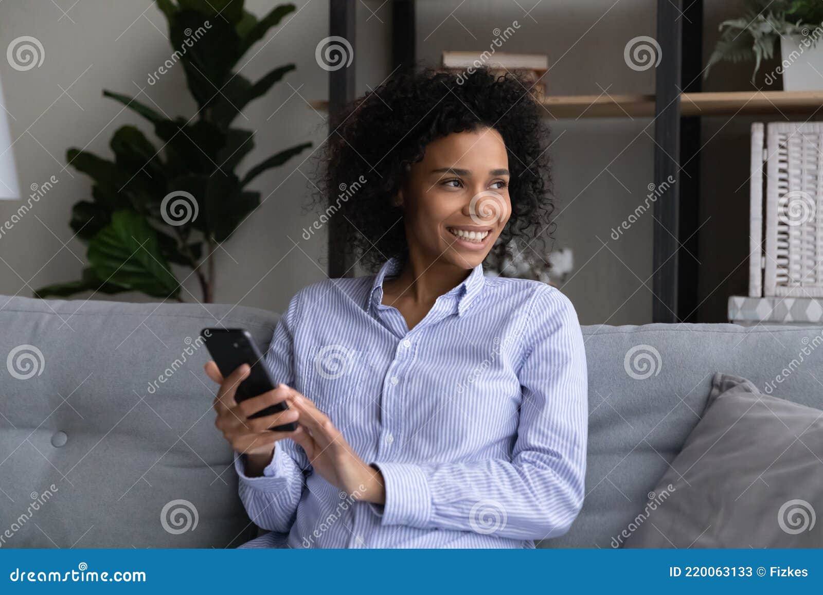 Smiling African American Woman Use Cellphone Dreaming Stock Image