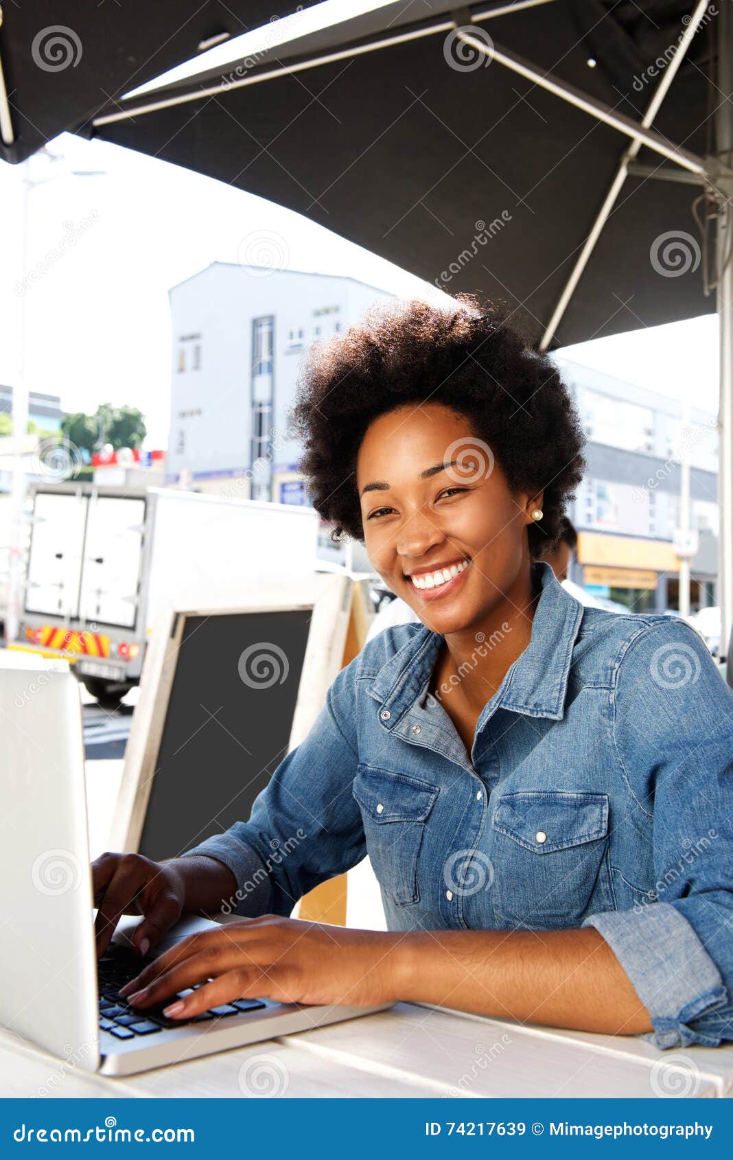 Smiling African Lady Working on Computer at Outdoor Cafe Stock Image ...
