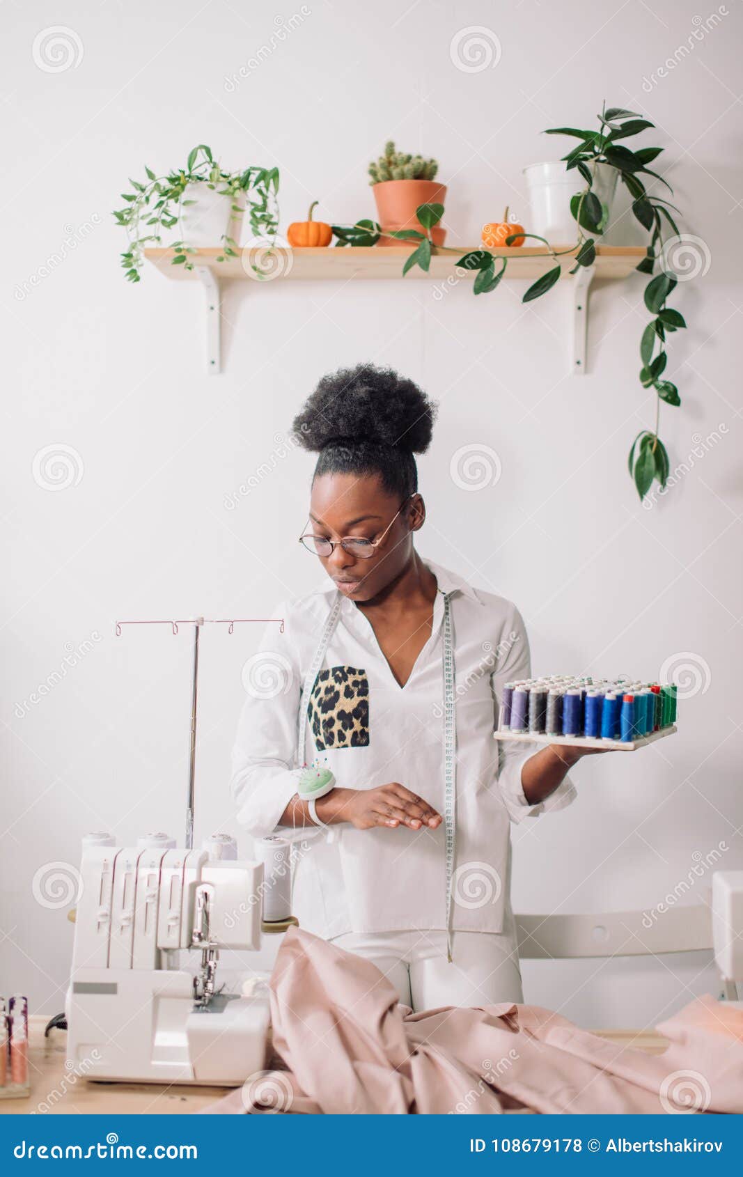 African Seamstress Holding Coils with Threads Stock Photo - Image of ...
