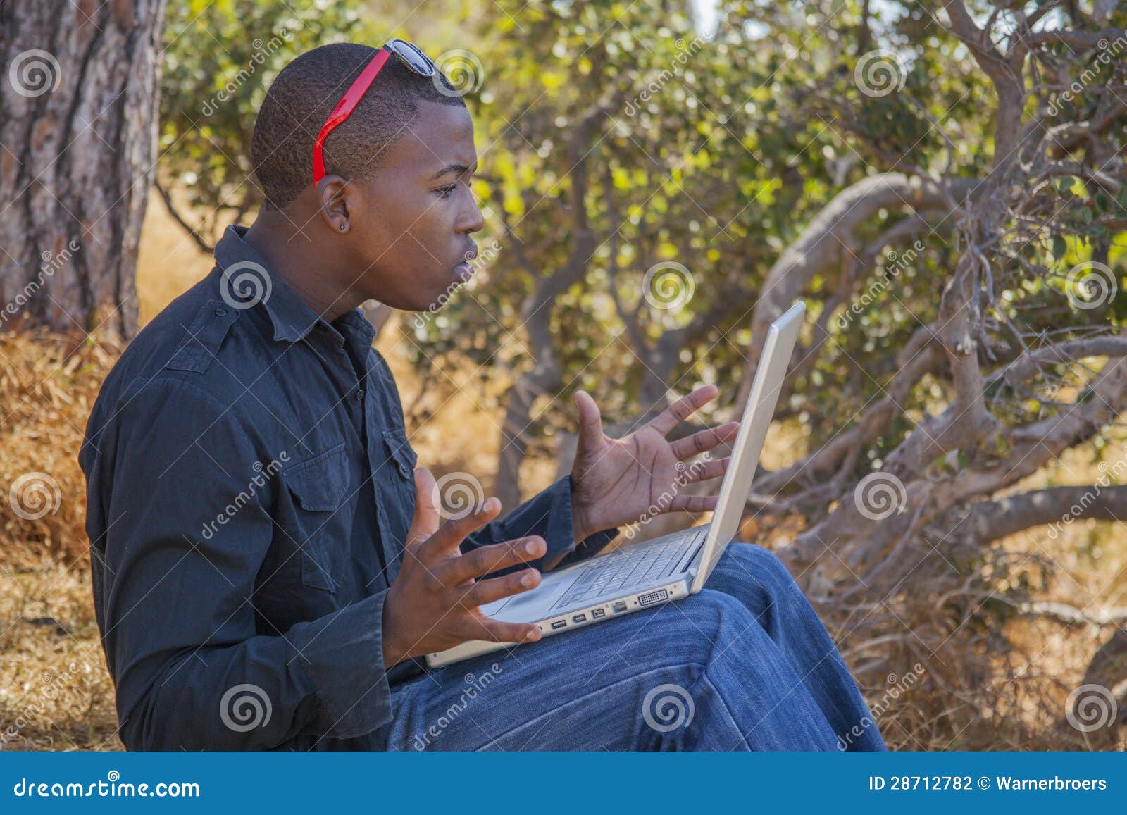 Smiling African Student Using a Laptop Stock Photo - Image of teen ...