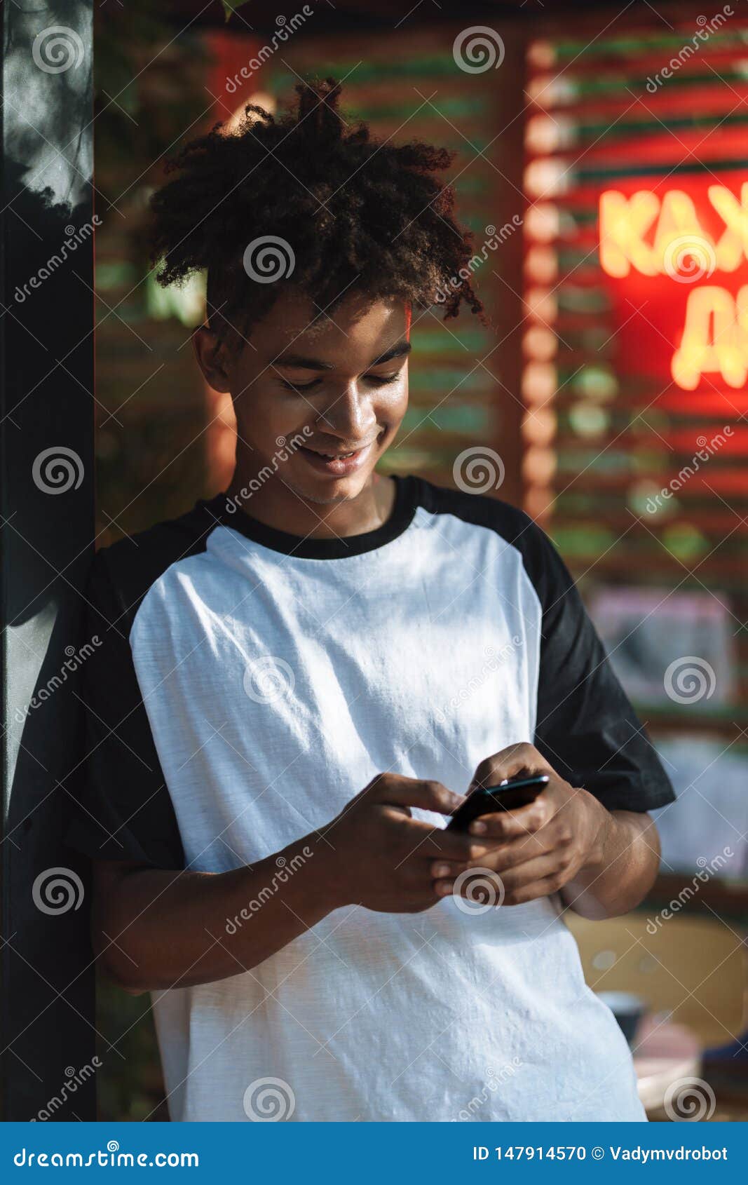 Smiling African Young Man Using Mobile Phone Stock Photo - Image of ...
