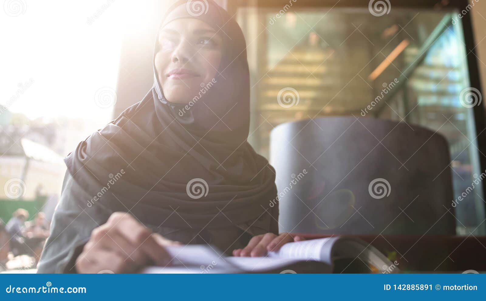 Smiling Arabic Woman Sitting Cafe Table with Book Studying, Education ... Smiling Arabic Woman Sitting Cafe Table with Book Studying, Education ...