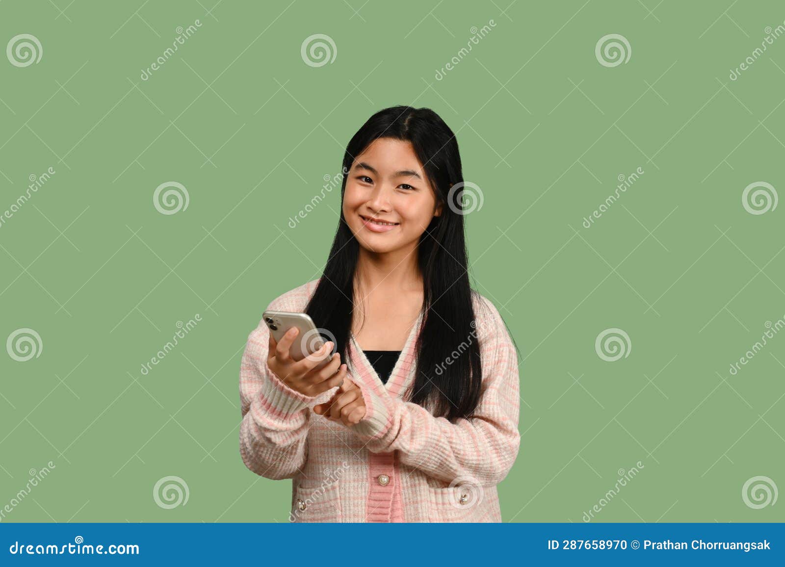 Smiling Asian Girl Using Smartphone Isolate on Green Background. People ...