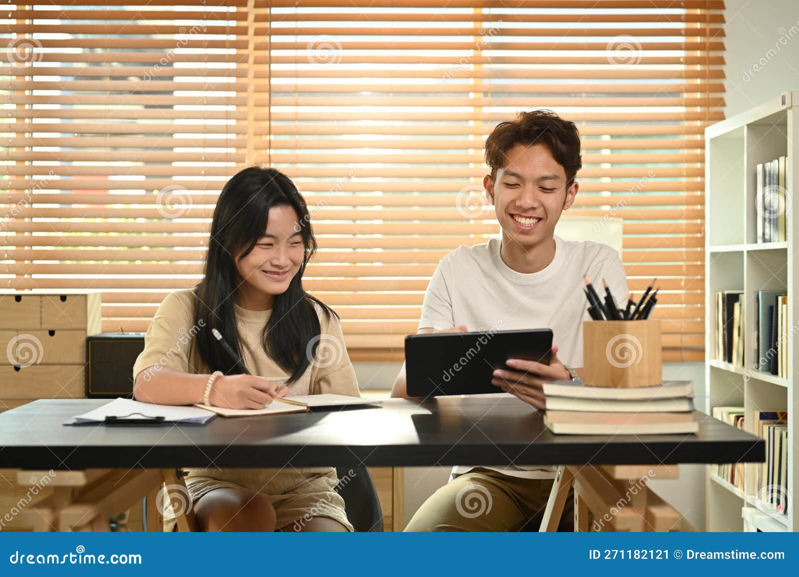 Smiling Asian Male Private Tutor Helping Young Student with Homework ...