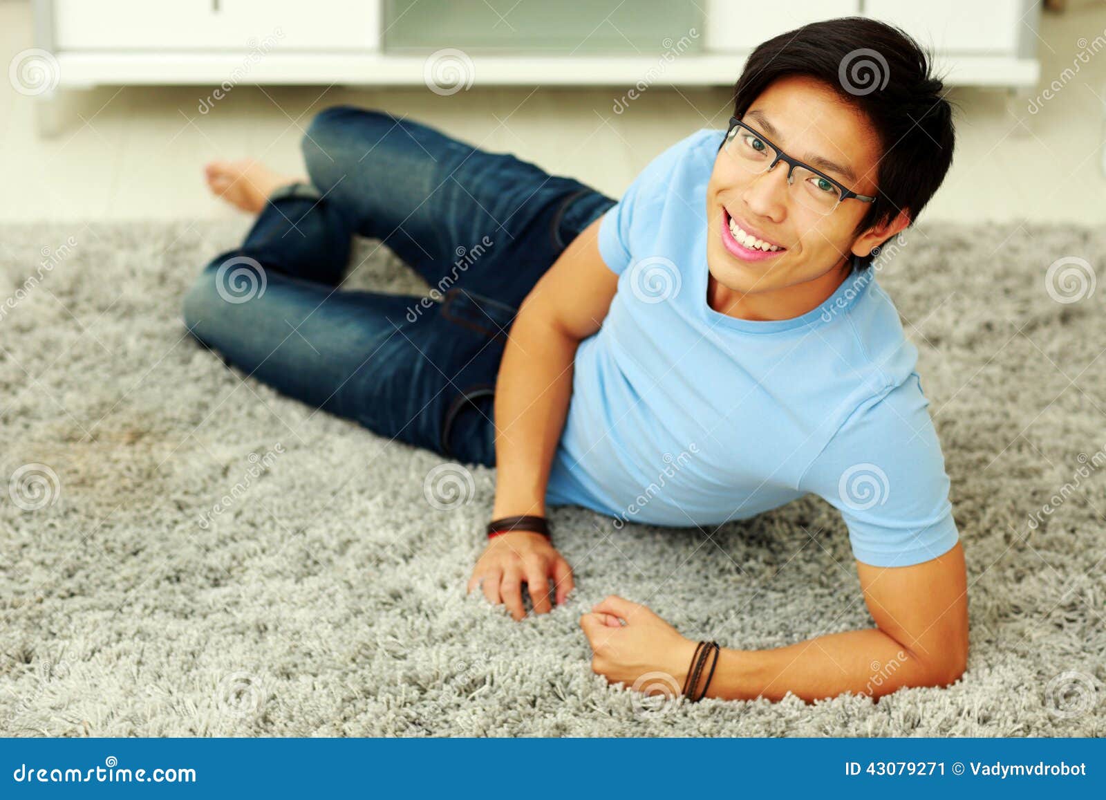 Smiling Asian Man Lying on the Floor Stock Image - Image of male ...