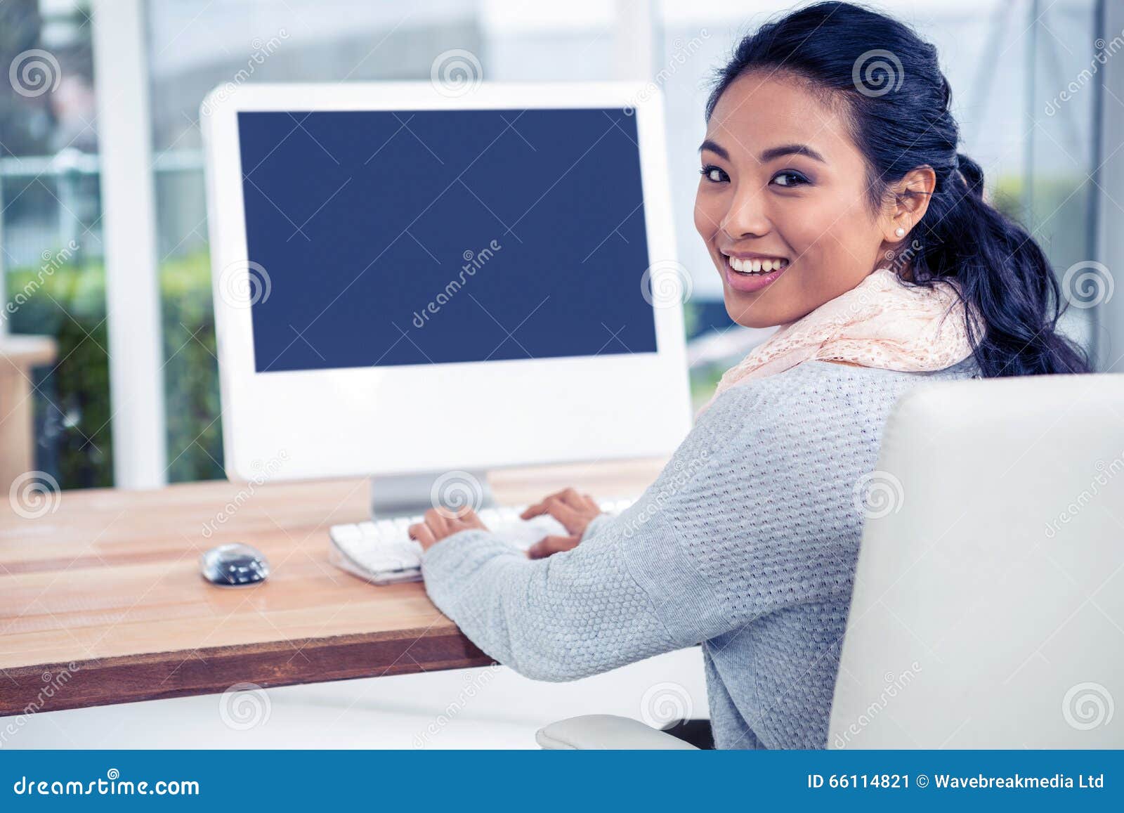 Smiling Asian Woman Using Computer Looking Back at the Camera Stock ...