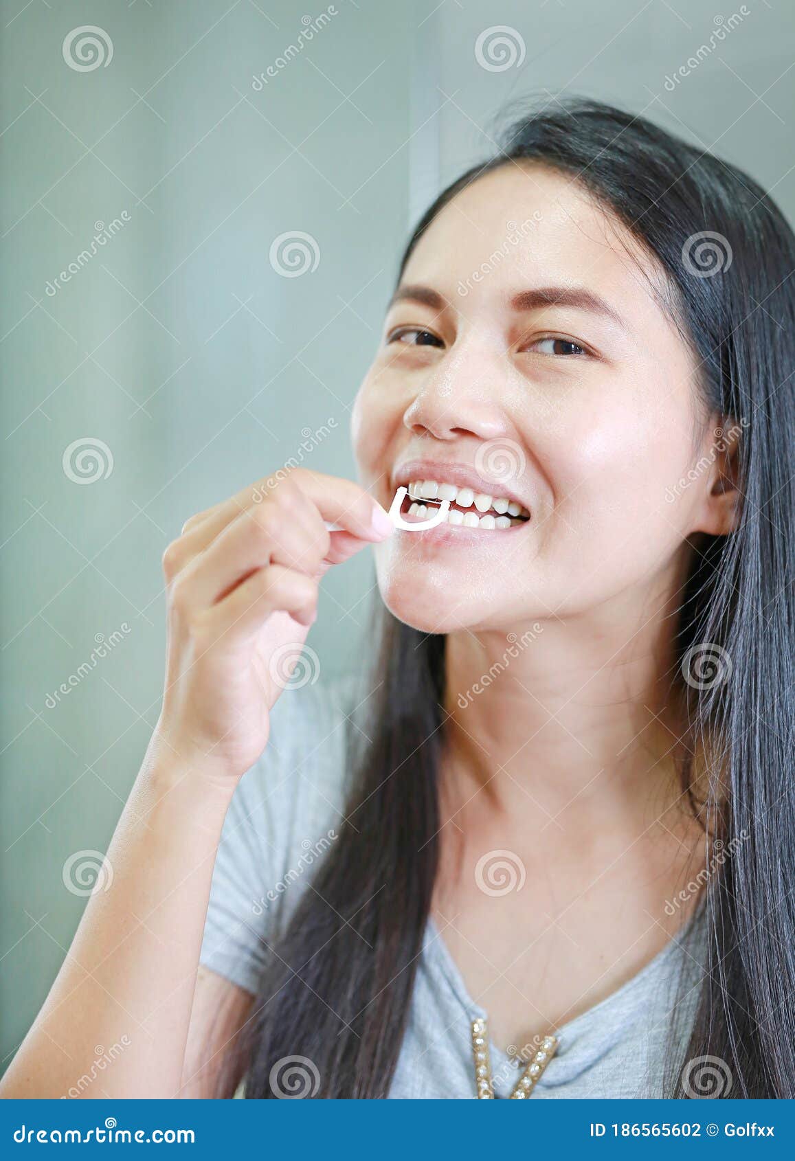 Smiling Asian Women Using Dental Floss for Healthy Teeth Stock Photo ...